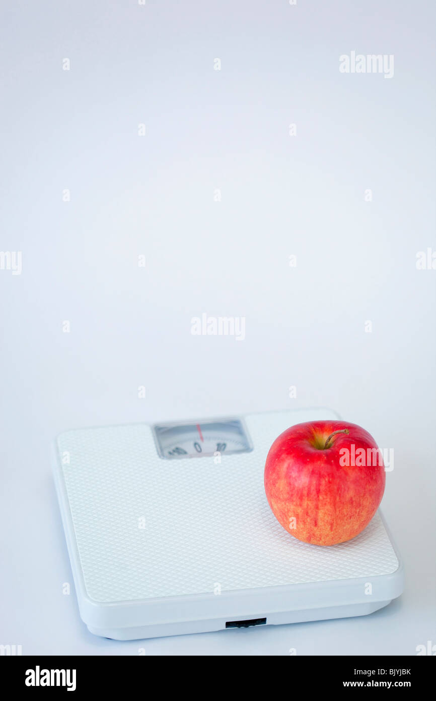 Apple on scale Stock Photo - Alamy