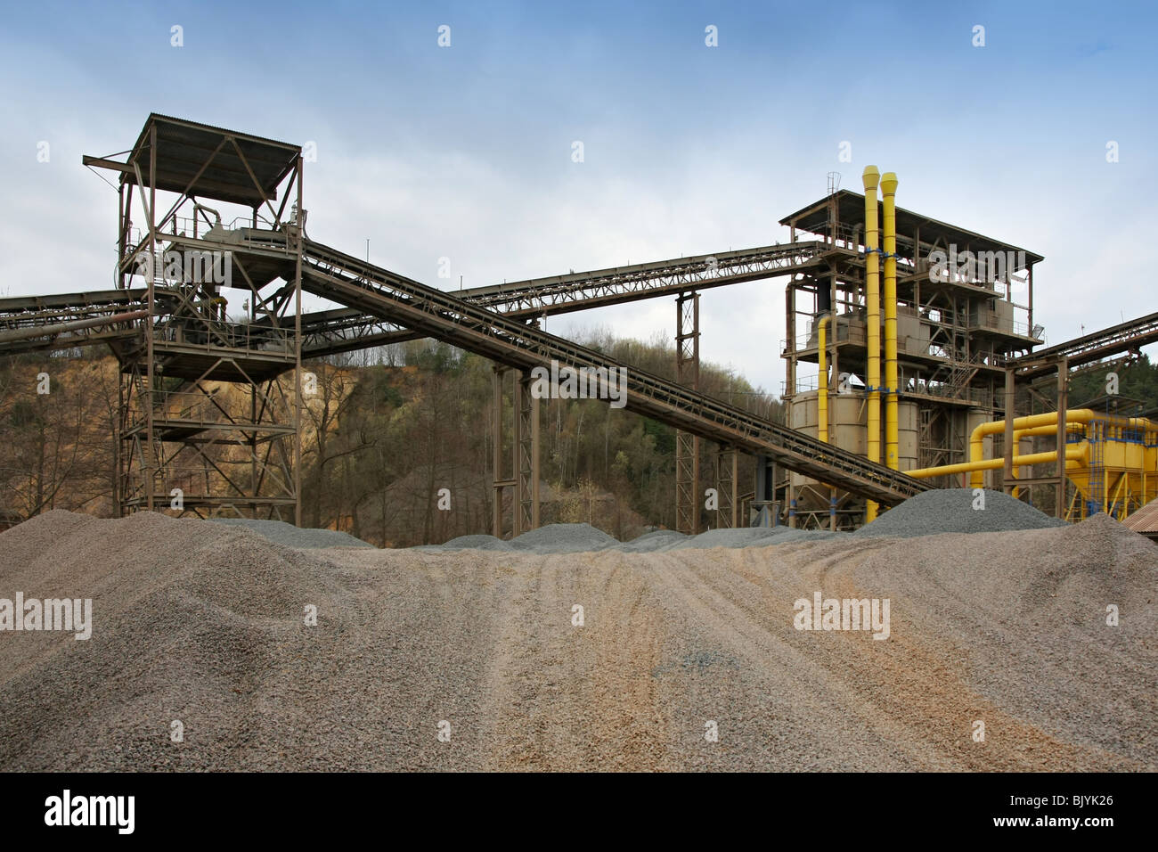 Stone quarry with silos, conveyor belts and piles of stones Stock Photo ...