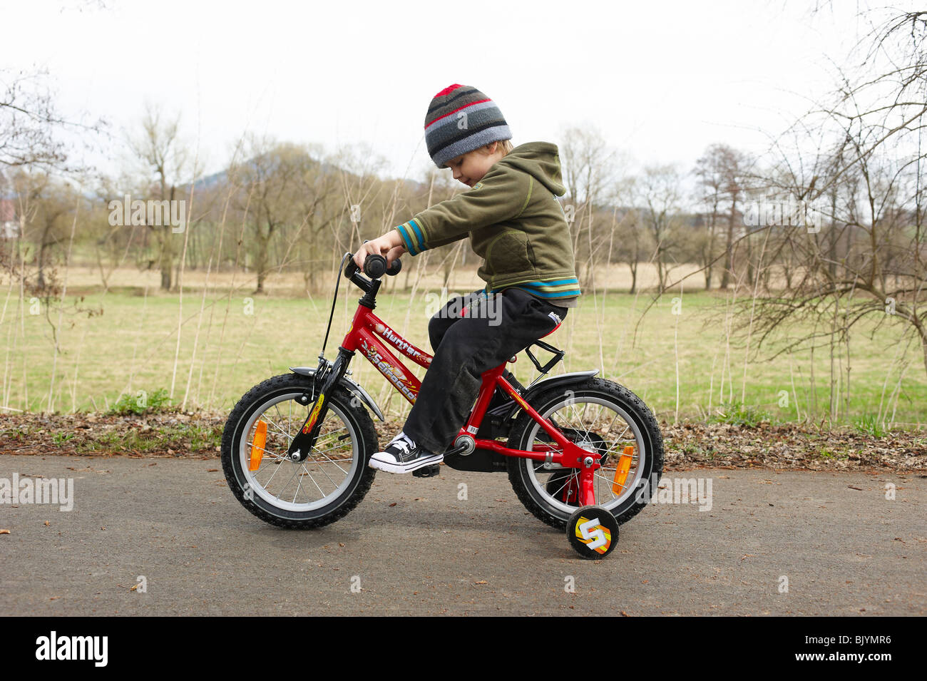 Boy Learning to Ride Bicycle Stock Photo - Alamy