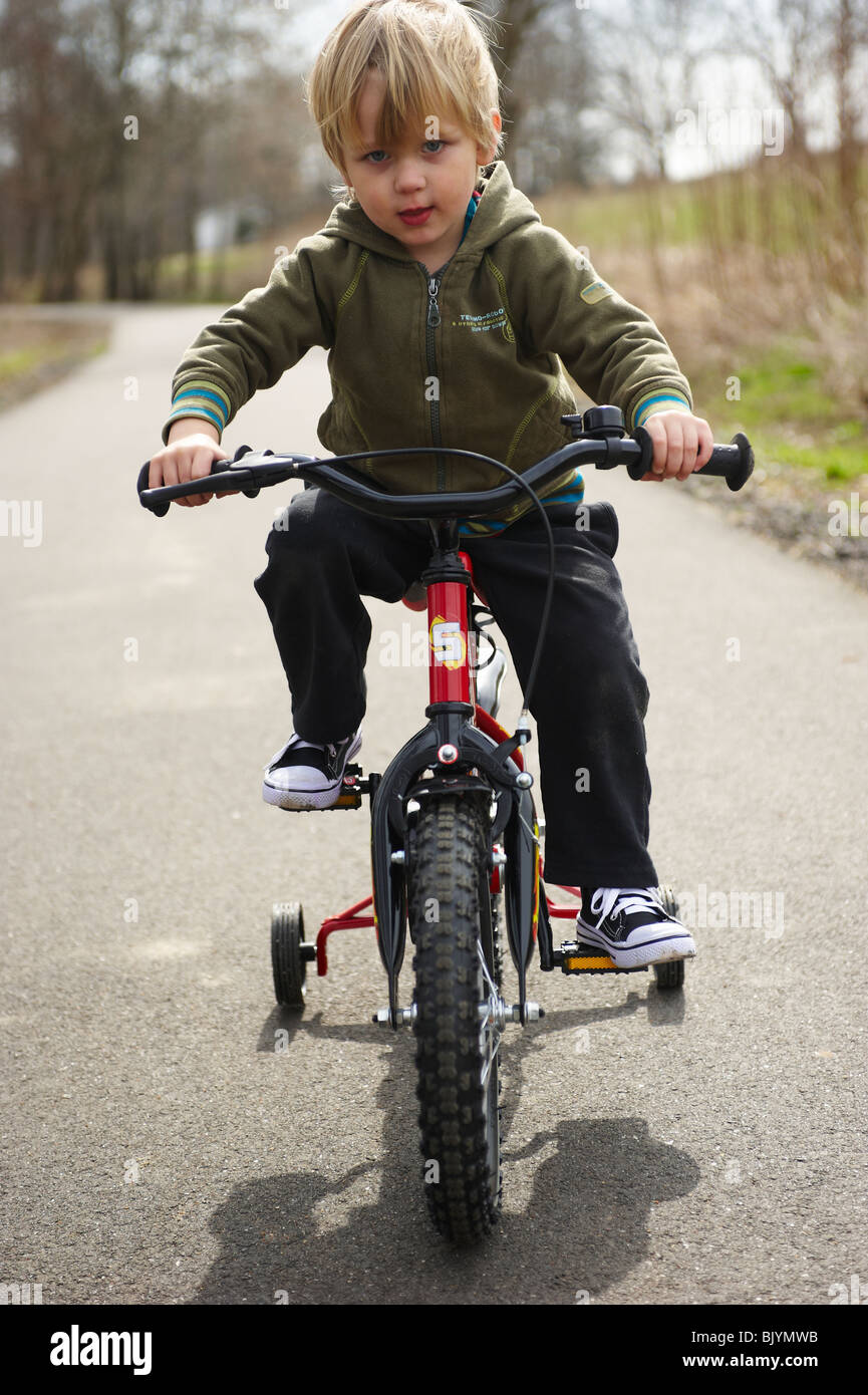 Boy Learning to Ride Bicycle Stock Photo - Alamy
