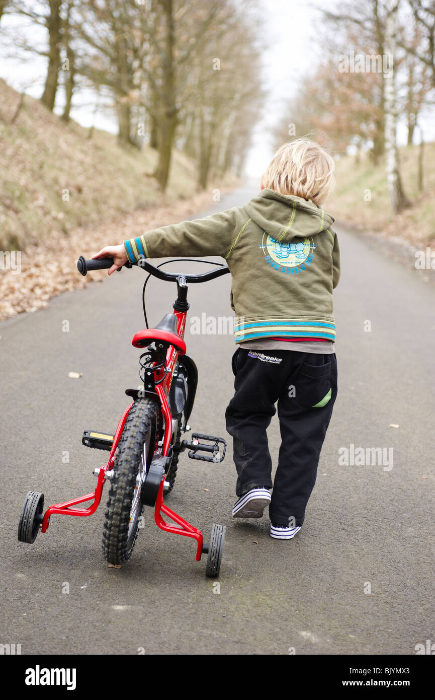 Boy Learning to Ride Bicycle Stock Photo - Alamy