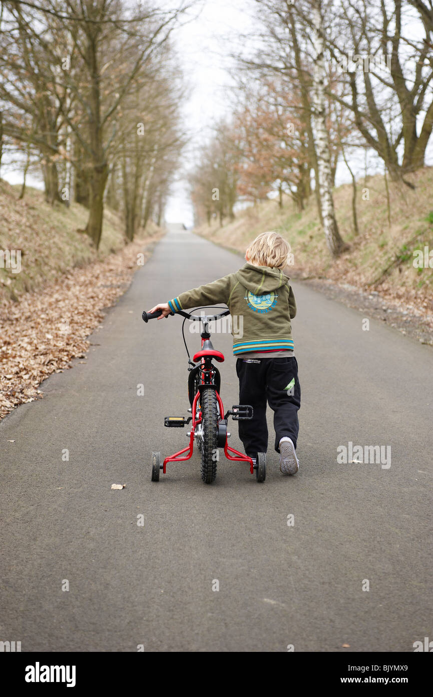 Boy Learning to Ride Bicycle Stock Photo - Alamy