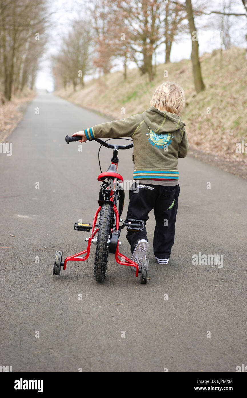 Boy Learning to Ride Bicycle Stock Photo - Alamy
