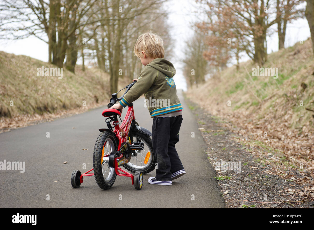 Boy Learning to Ride Bicycle Stock Photo - Alamy