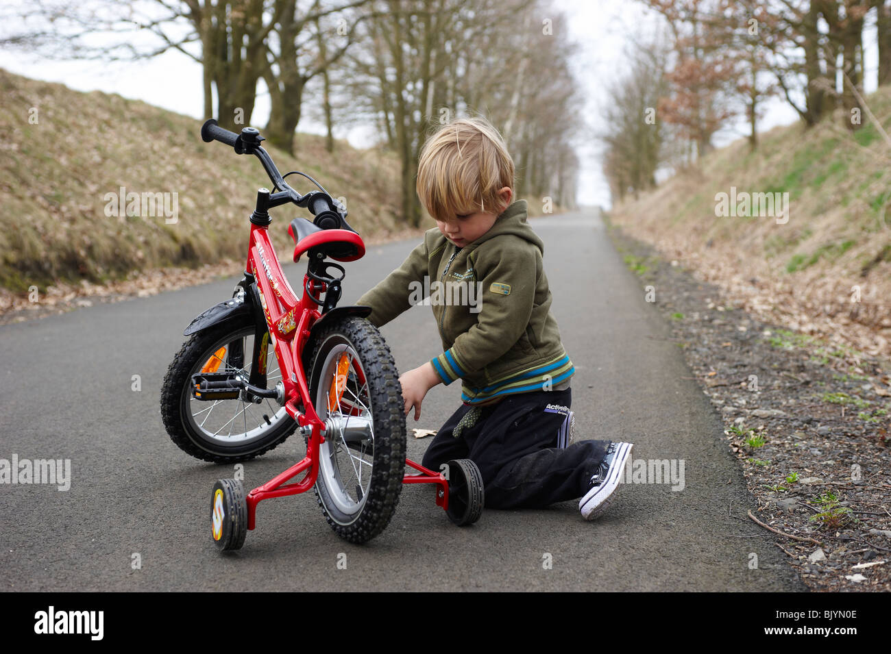 Boy Learning to Ride Bicycle Stock Photo - Alamy