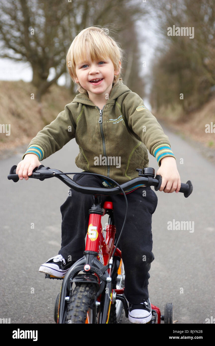Boy Learning to Ride Bicycle Stock Photo - Alamy