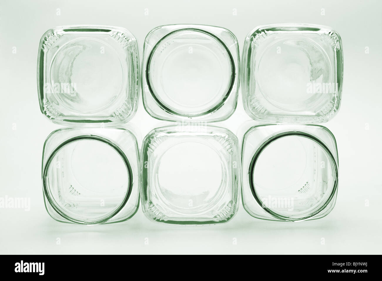 Stack of empty glass containers on seamless background Stock Photo - Alamy