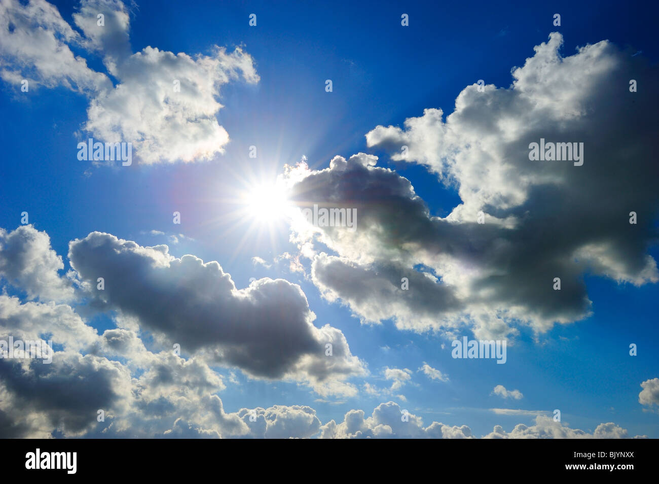 cloudy blue sky with bright shiny sun Stock Photo - Alamy