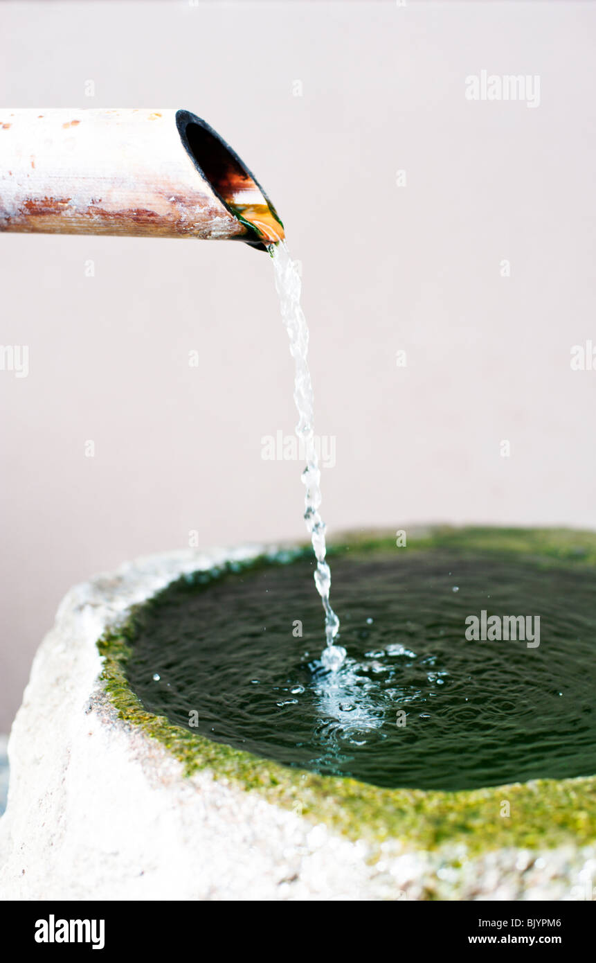 Onsen or hot spring water falls into basins from the Wata-no-yu spring ...
