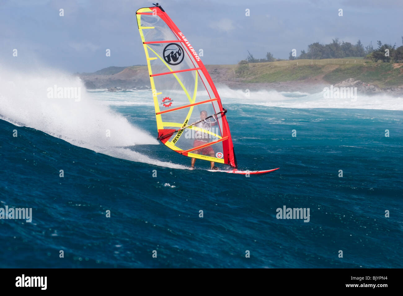 A windsurfer turns off the bottom of the wave at Ho'okipa in Paia, Maui ...