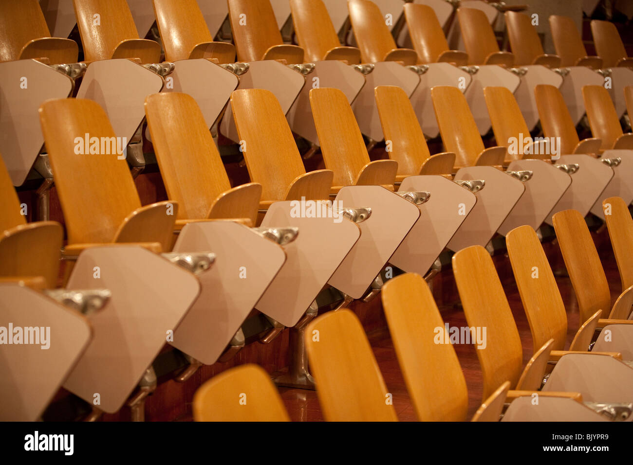 rows of wooden chairs in a university lecture hall Stock Photo - Alamy