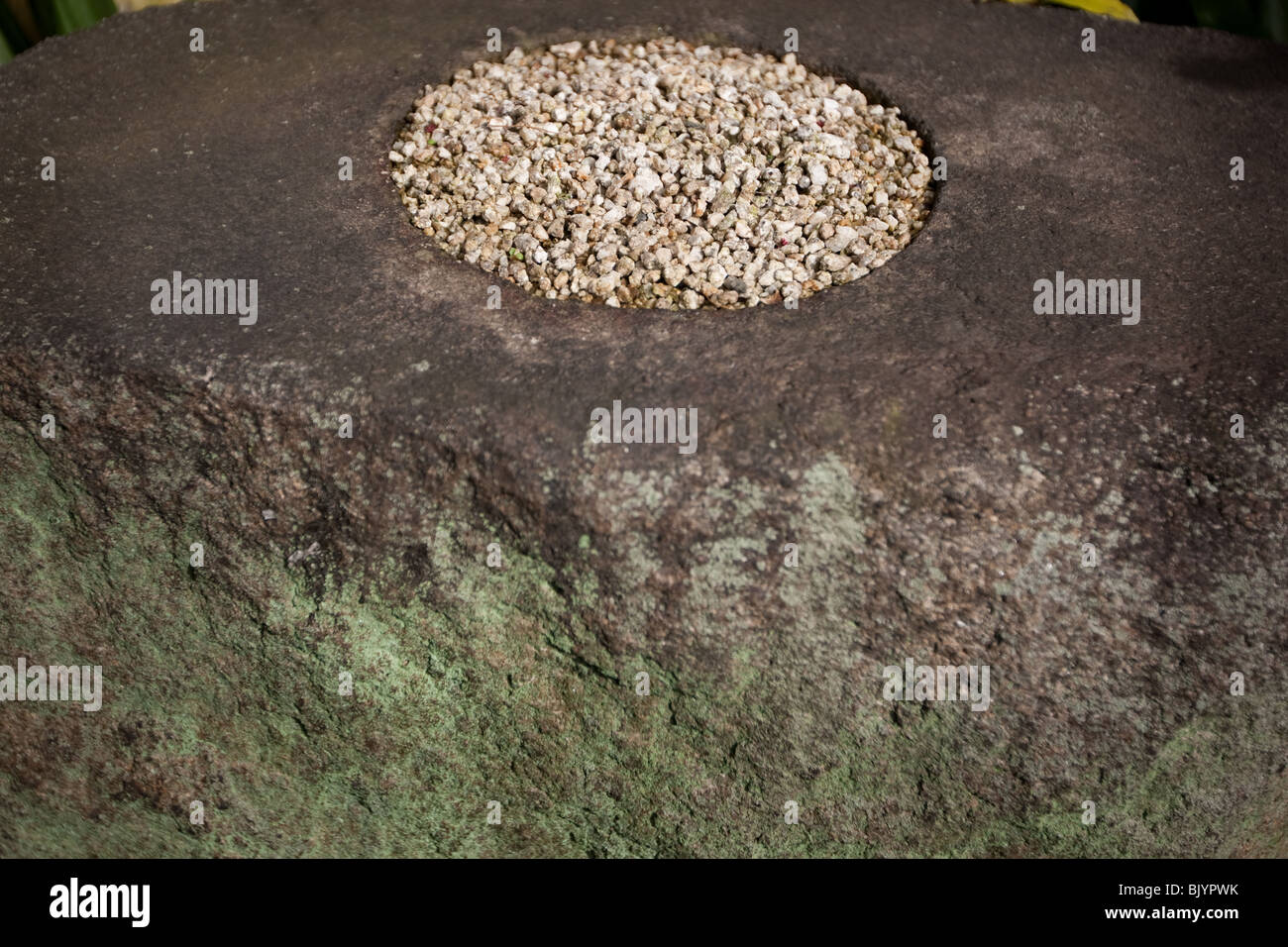 Circle of stones/pebbles on a larger stone/ rock Stock Photo - Alamy
