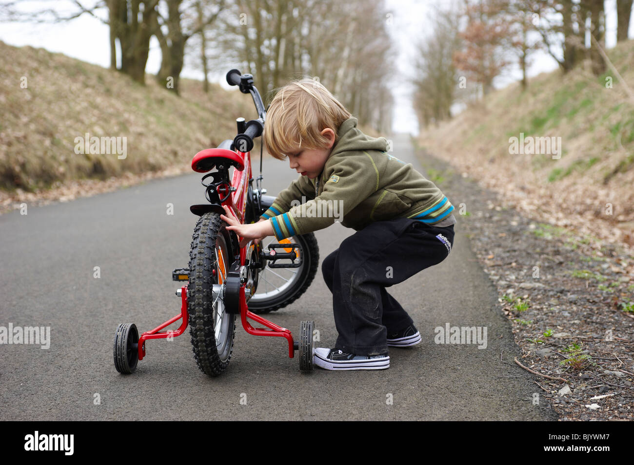 Boy Learning to Ride Bicycle Stock Photo - Alamy
