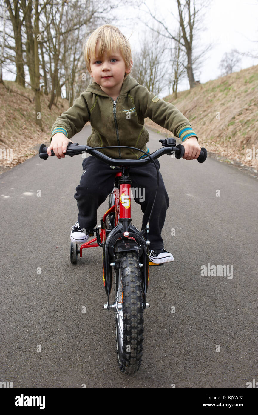 Boy Learning to Ride Bicycle Stock Photo - Alamy