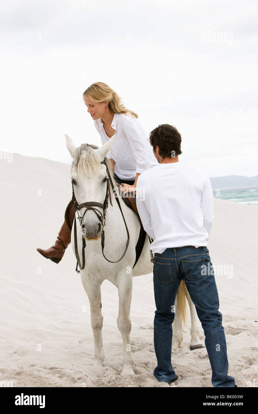 Woman mounting horse hi-res stock photography and images - Alamy