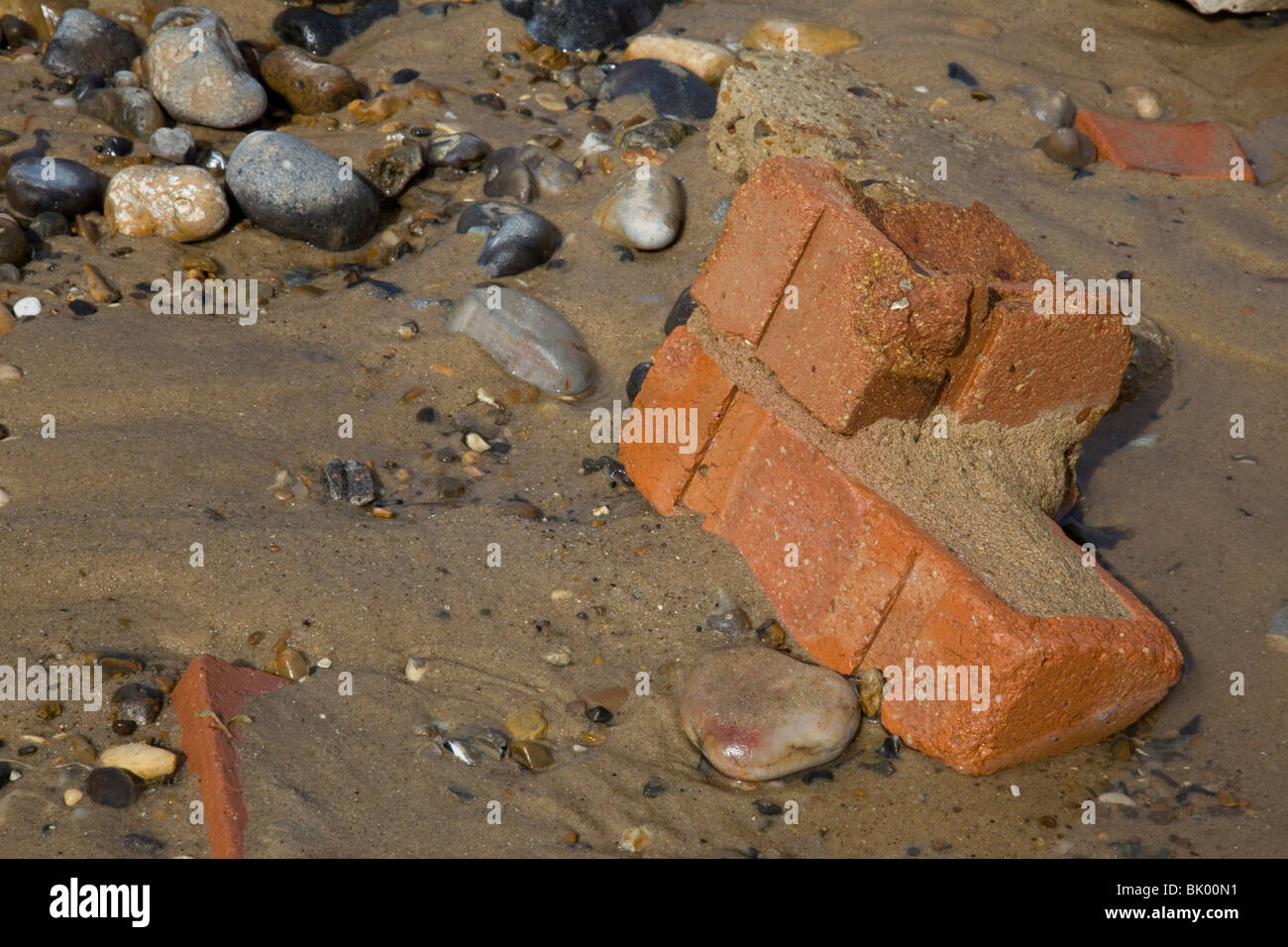 Happisburgh Beack UK - bricks on beach showing coastal erosion Stock ...