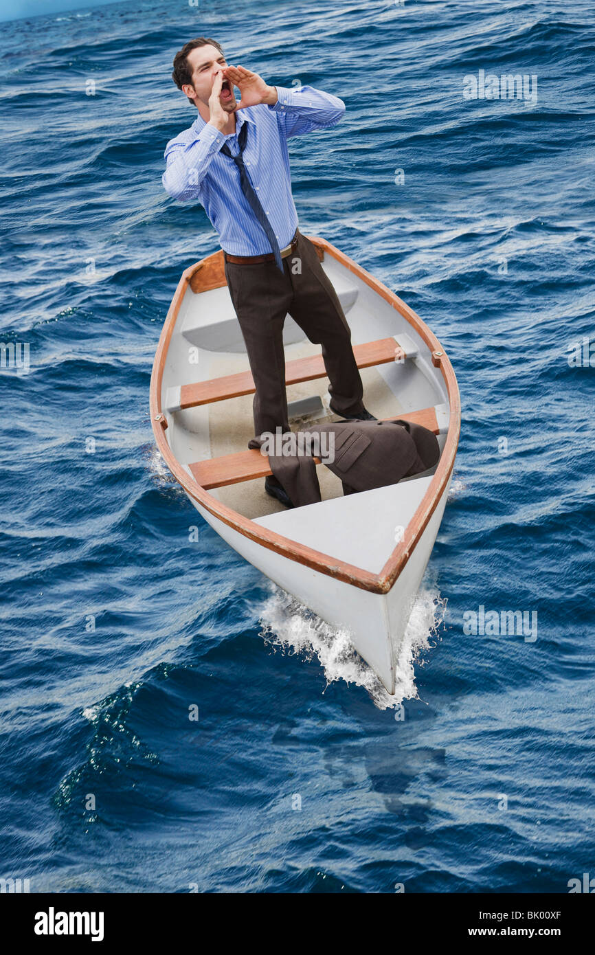 Man in a little boat crying for help Stock Photo - Alamy
