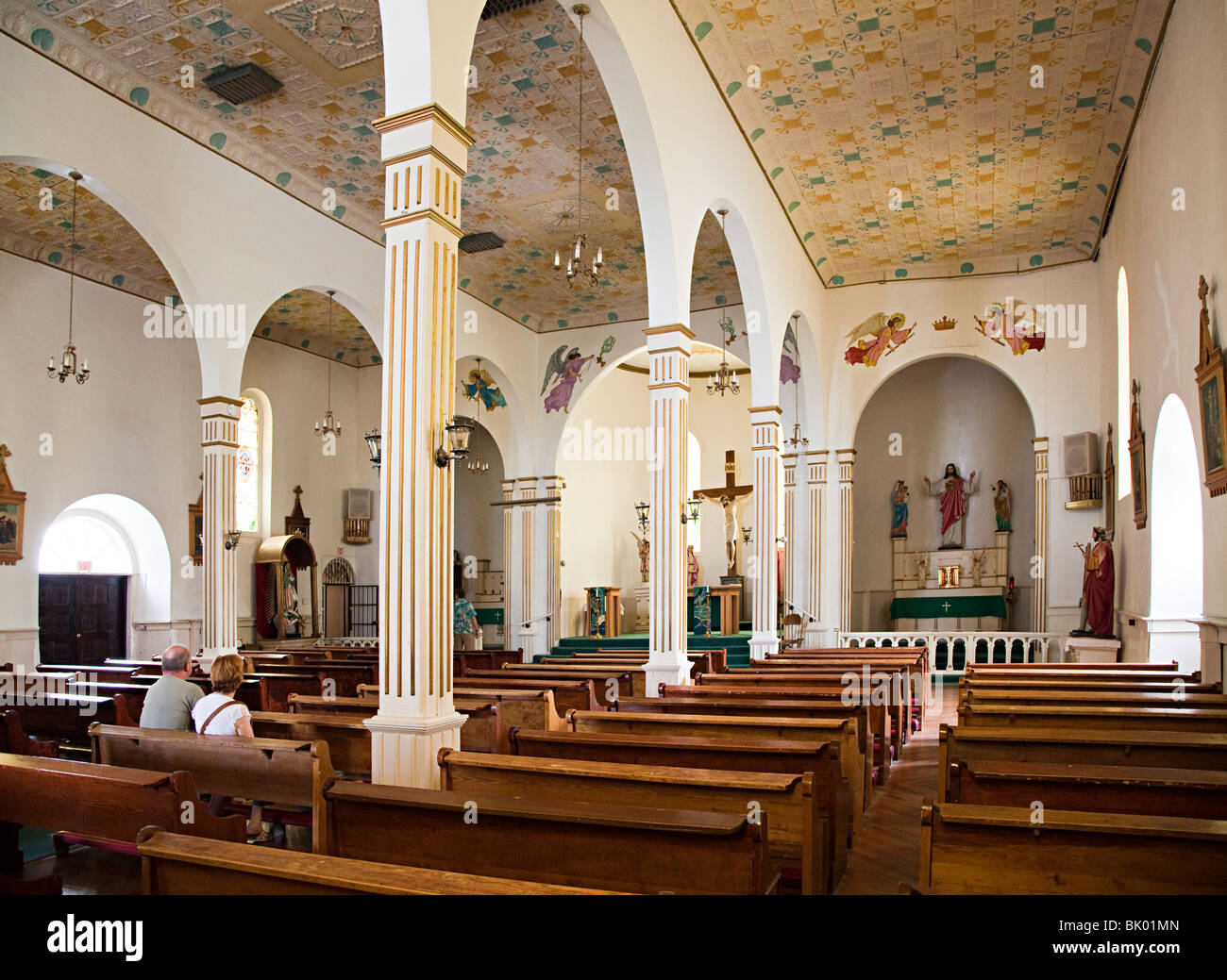 Two people sitting in pews in San Elizario Presidio Chapel El Paso ...