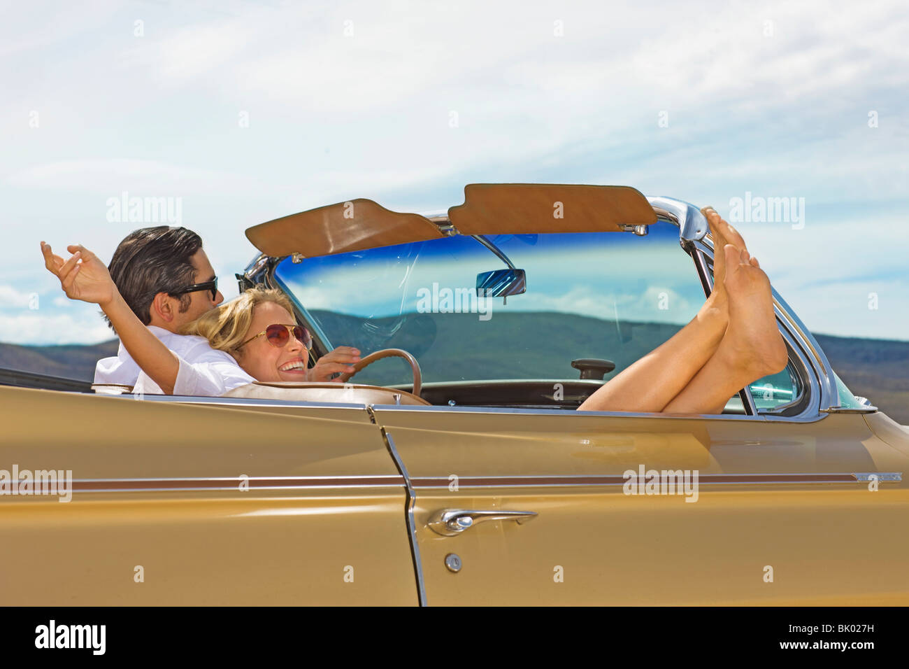 Happy couple in convertible Stock Photo - Alamy