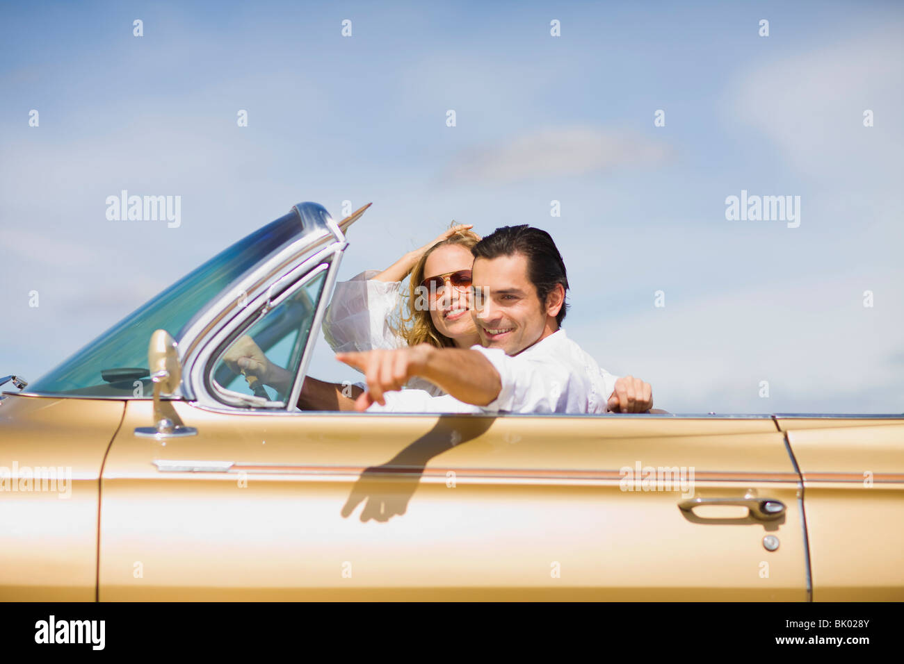 Young couple driving a convertible Stock Photo - Alamy