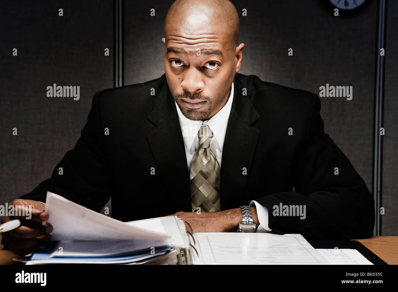 Man at desk doing paperwork Stock Photo - Alamy