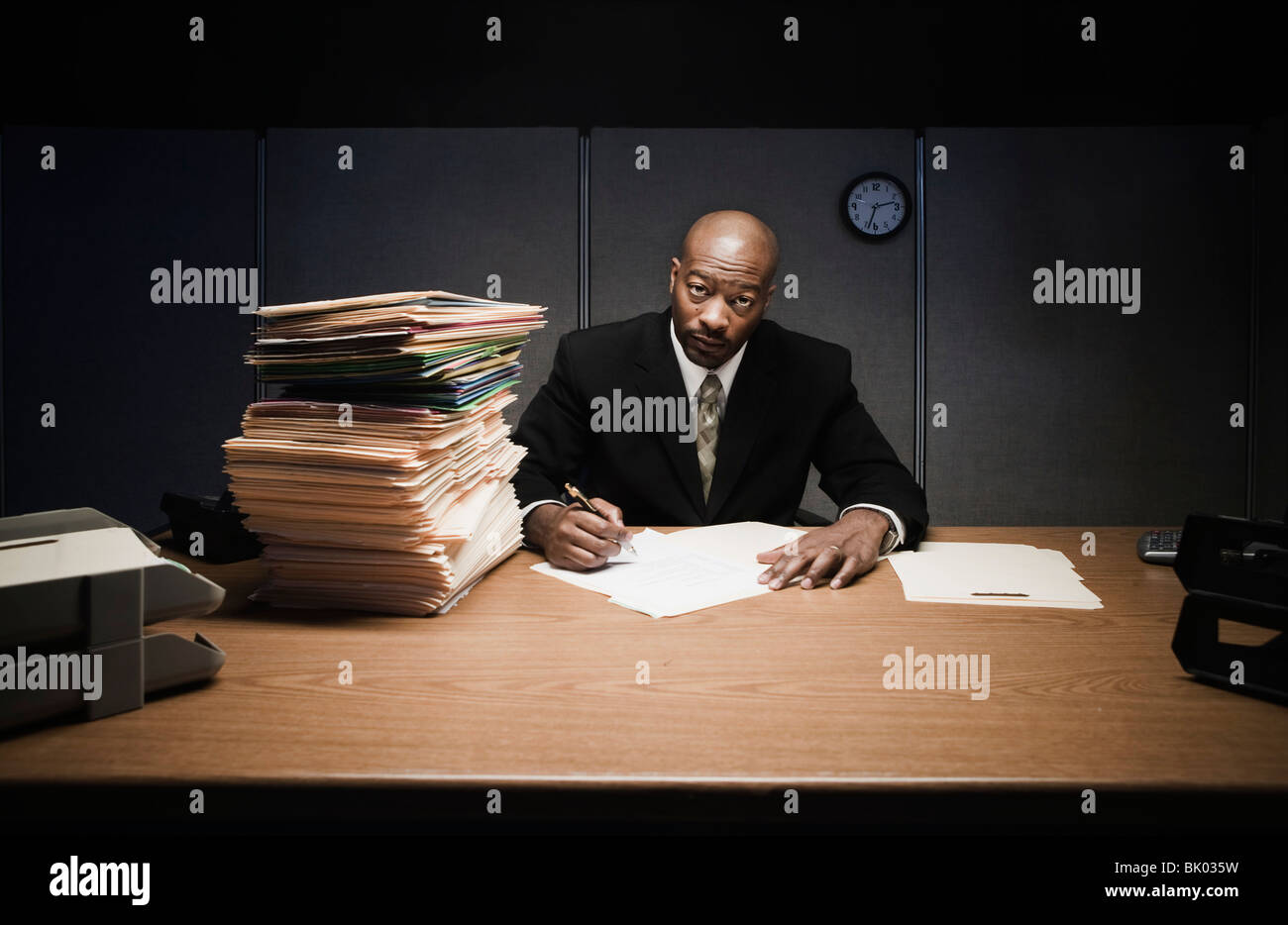Business man at desk doing paperwork Stock Photo - Alamy