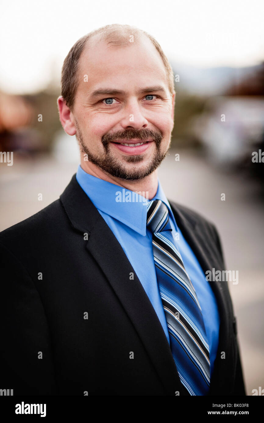 Portrait of smiling man in suit Stock Photo - Alamy