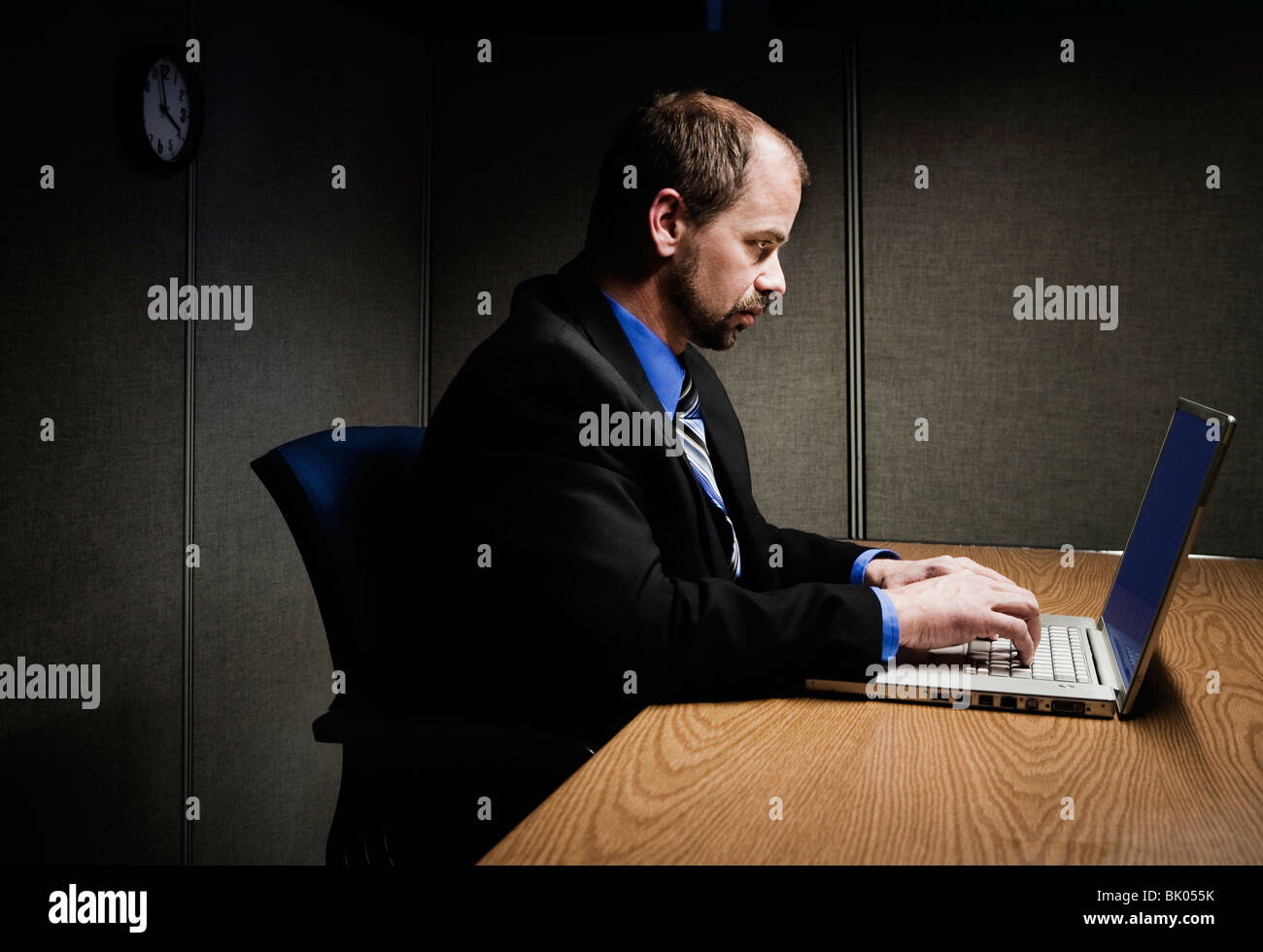 Man working at computer on desk Stock Photo - Alamy