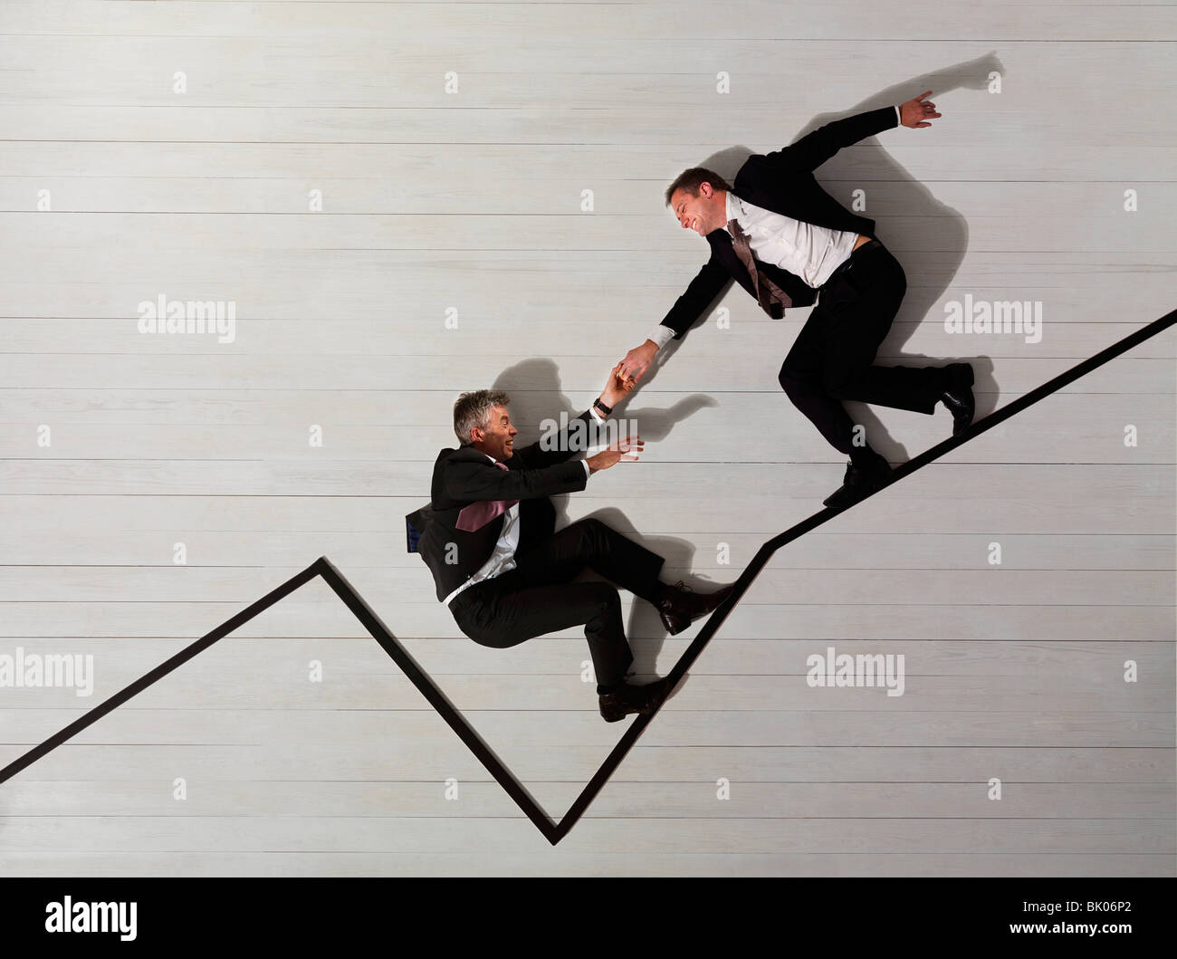 Business men climbing up graph Stock Photo - Alamy