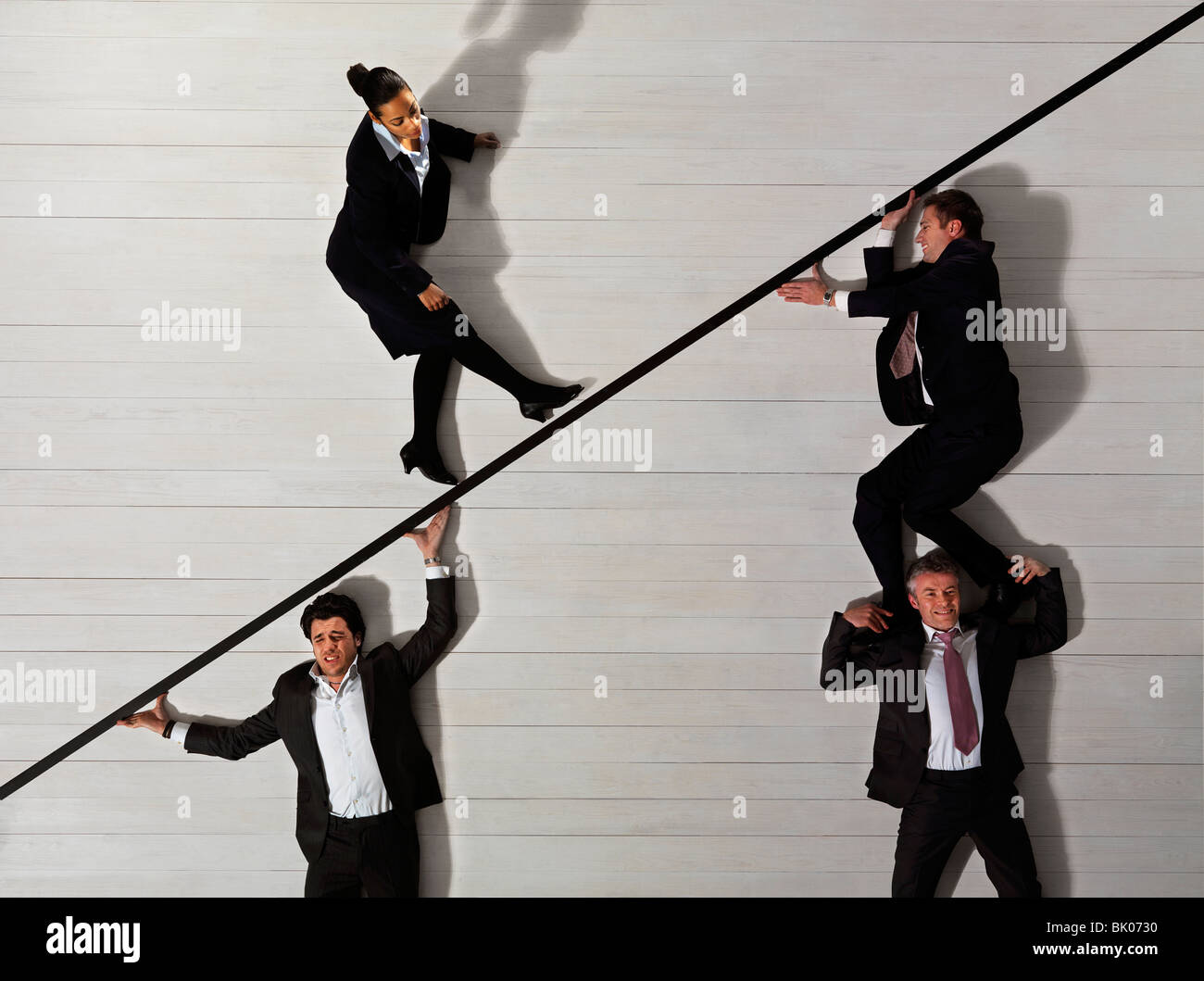 Business men supporting woman Stock Photo - Alamy