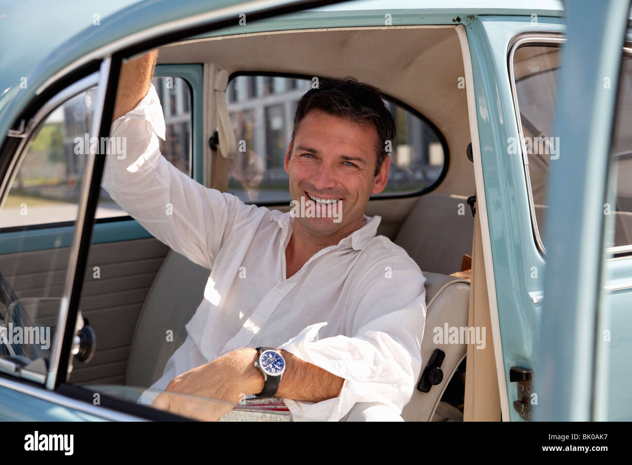 Man looking through car window Stock Photo - Alamy