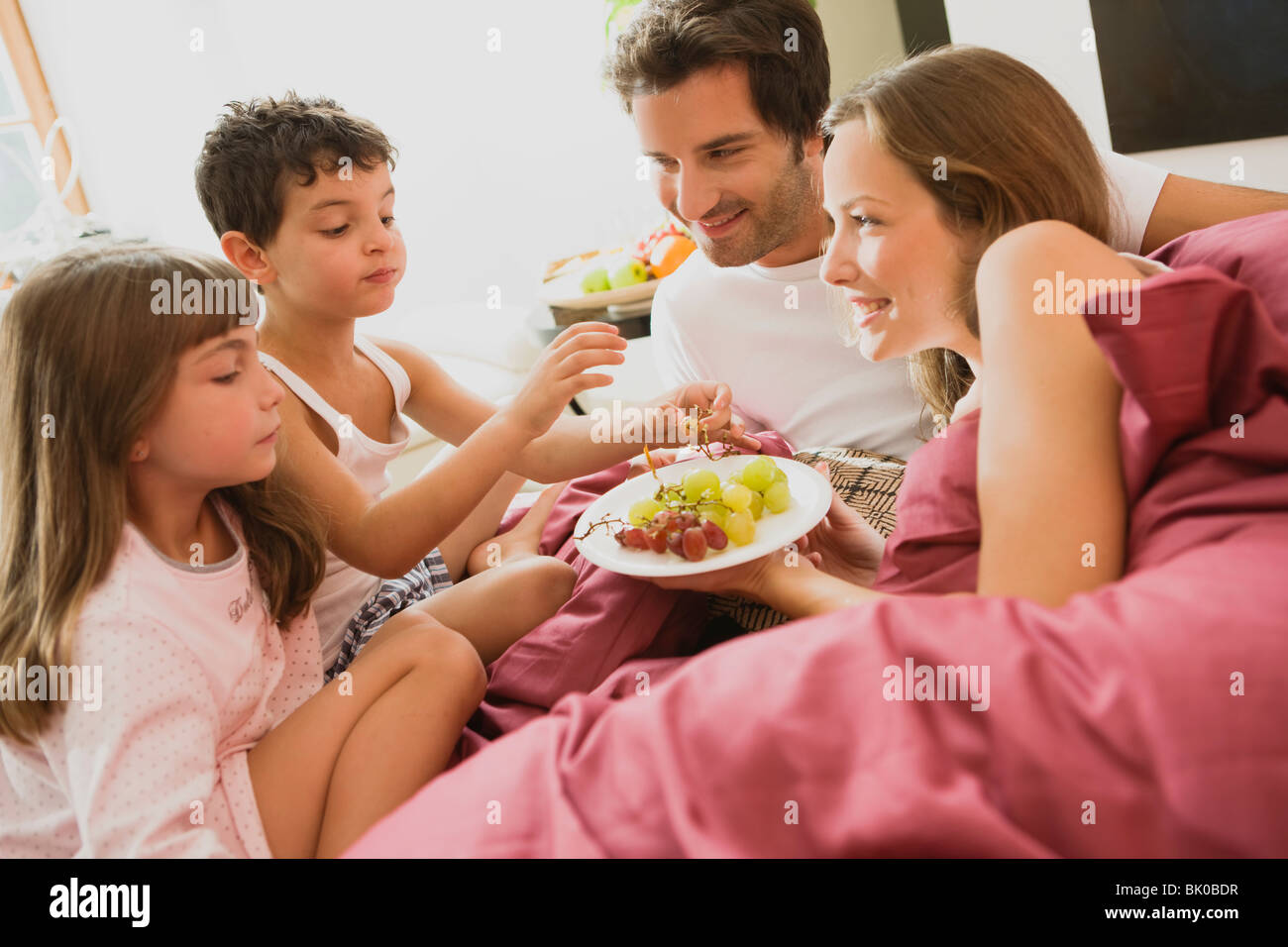 Family having breakfast in bed Stock Photo - Alamy
