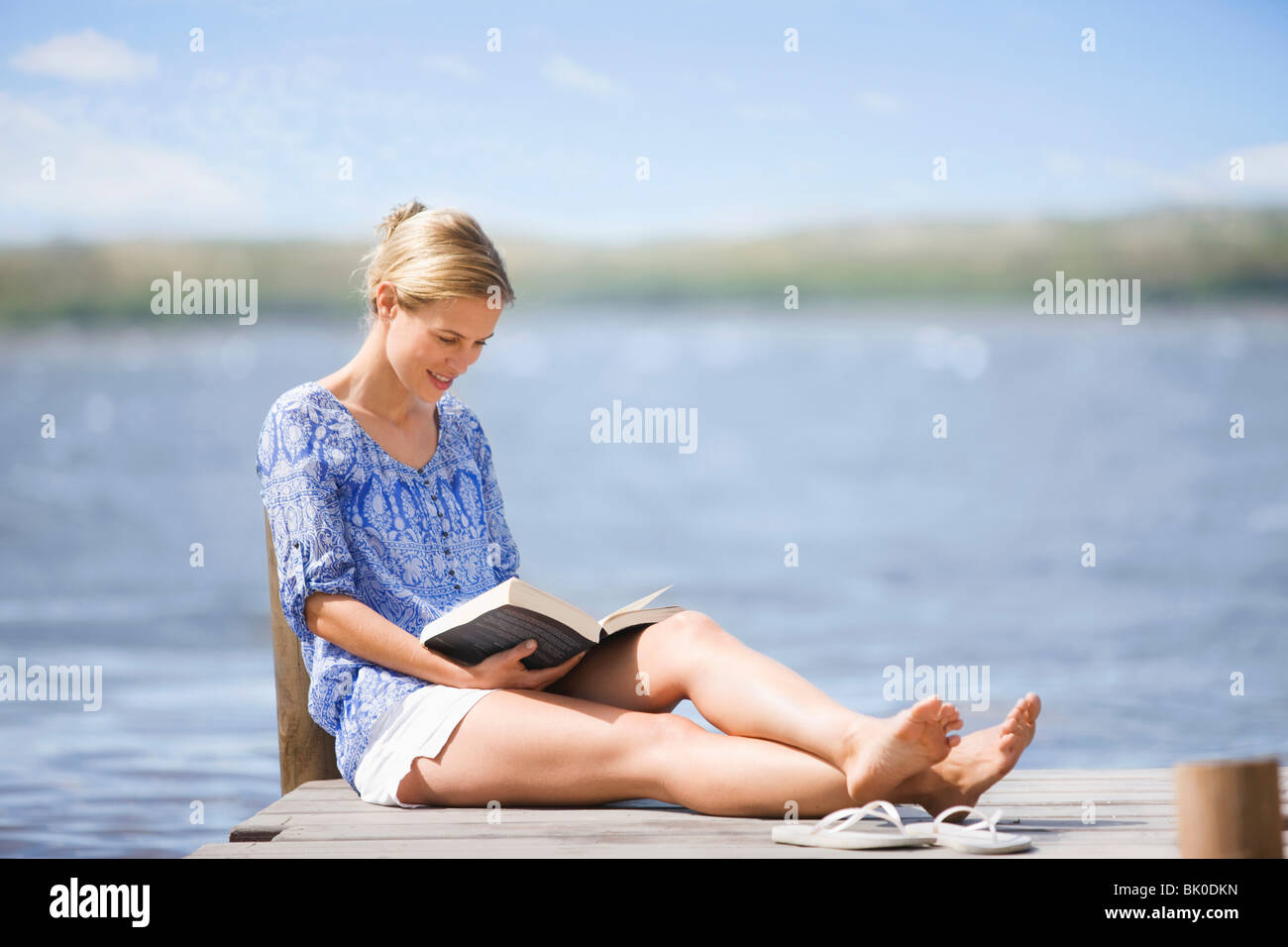 Woman reading book lake side hi-res stock photography and images - Alamy
