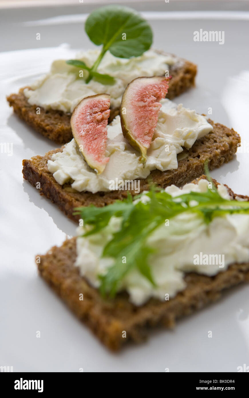 Pumpernickel rye bread canapes on a white plate Stock Photo - Alamy