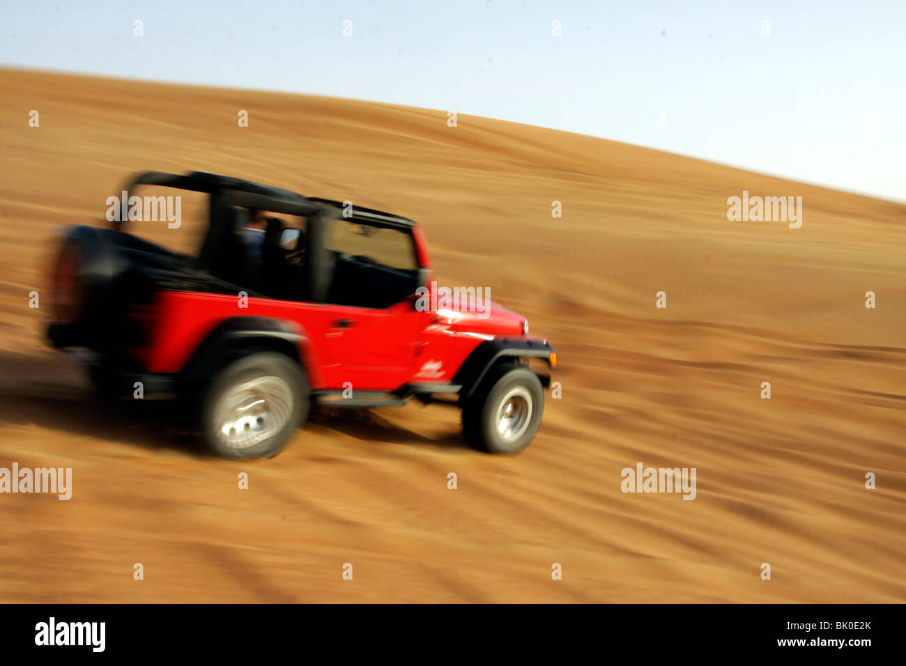 Jeep driving across the desert in Dubai, UAE Stock Photo - Alamy