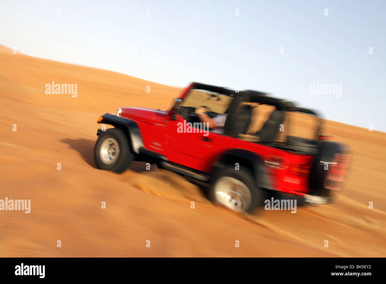 Jeep driving across the desert in Dubai, UAE Stock Photo - Alamy
