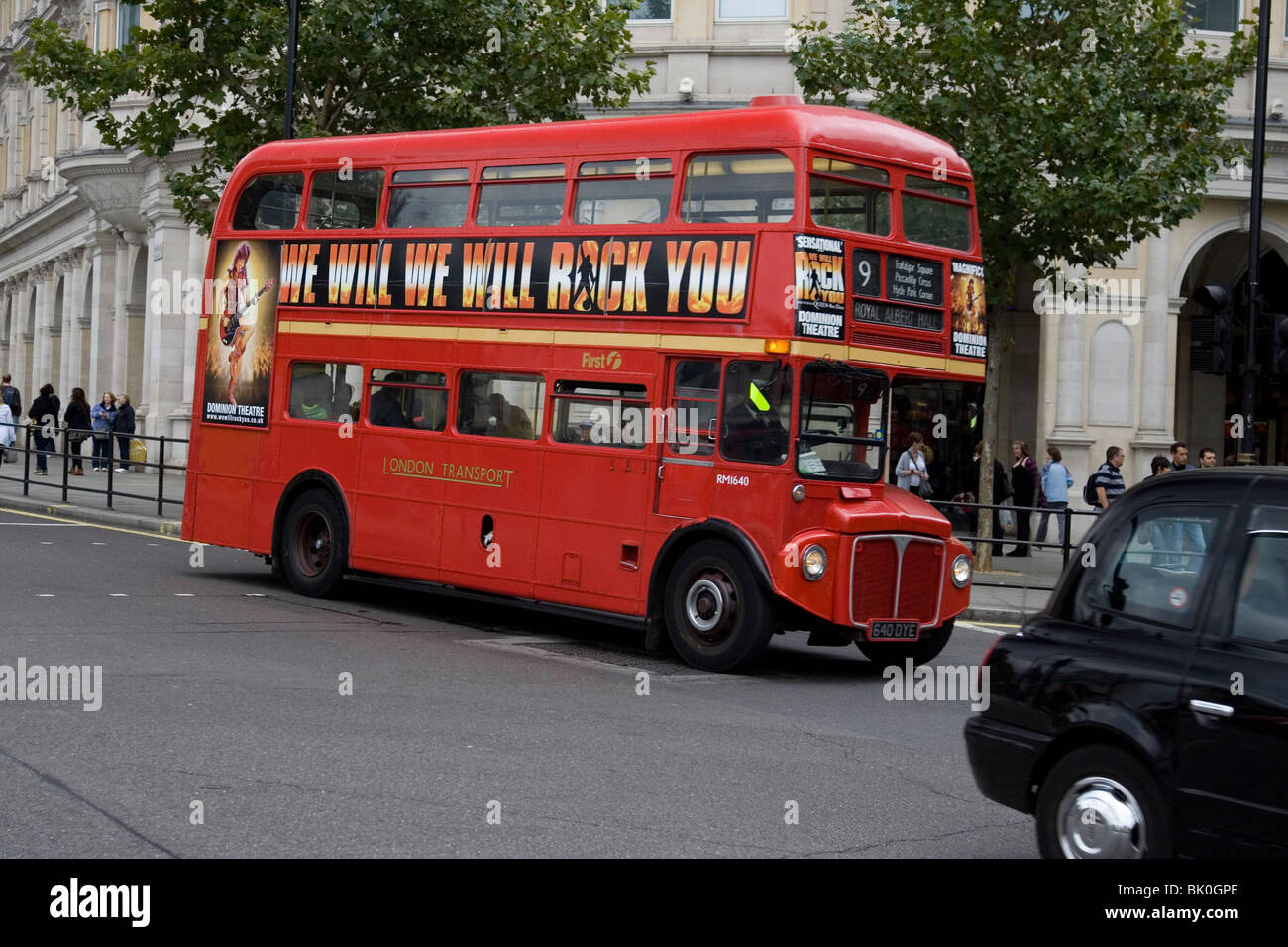 Red Routemaster RM1614 bus following a black taxi cab in London’s ...