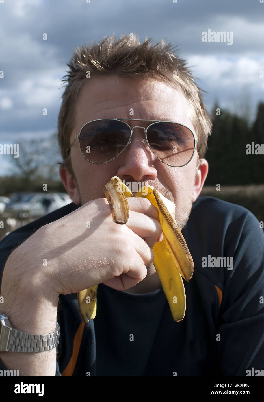 Man eating a banana Stock Photo - Alamy