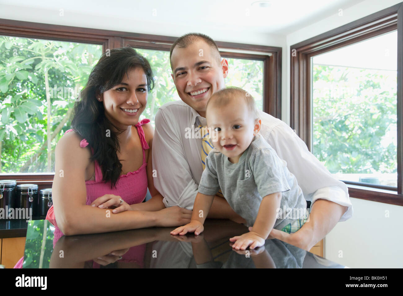 Family smiling in kitchen Stock Photo - Alamy