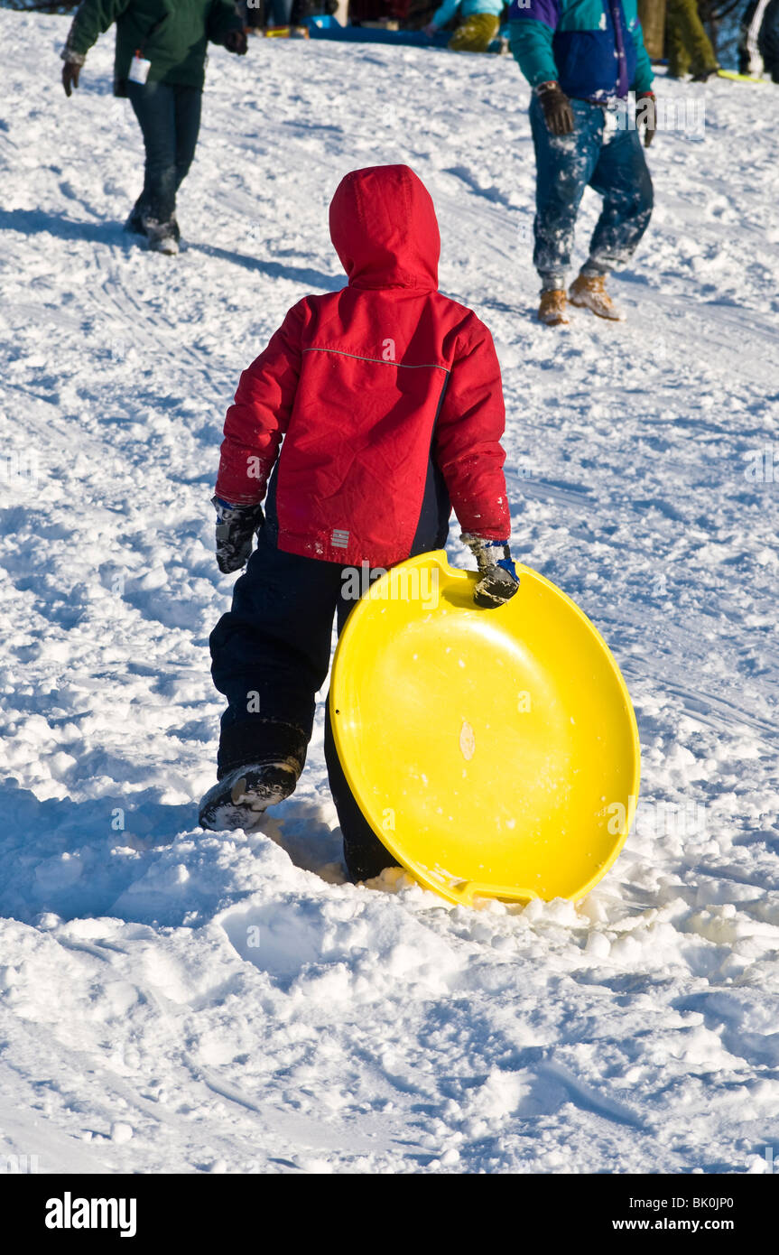 Young families children sleds on snowy city park hillside Stock Photo ...