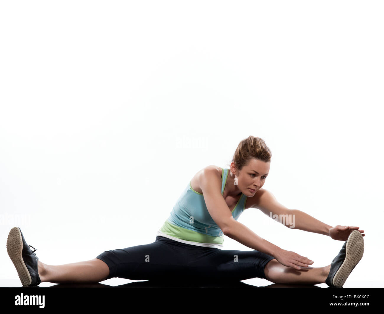 stretching workout posture by a woman on studio white background Stock ...