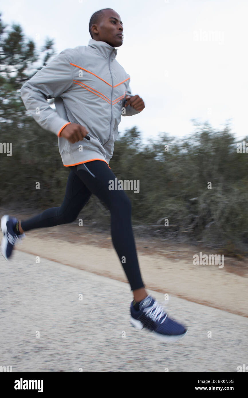Black man running on road Stock Photo - Alamy