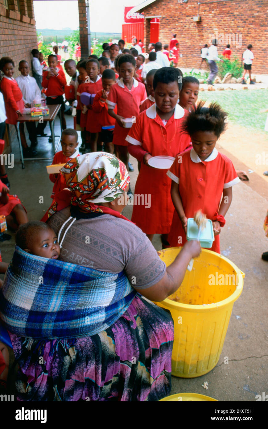 Primary school children queuing for their meals, Katlehong, South ...