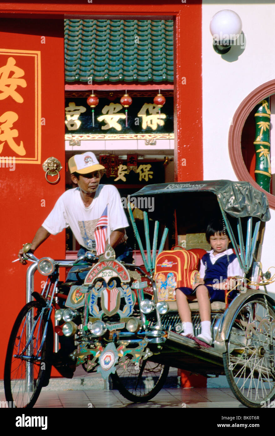 Schoolchild travelling in a bicycle rickshaw taxi, Malaysia Stock Photo ...