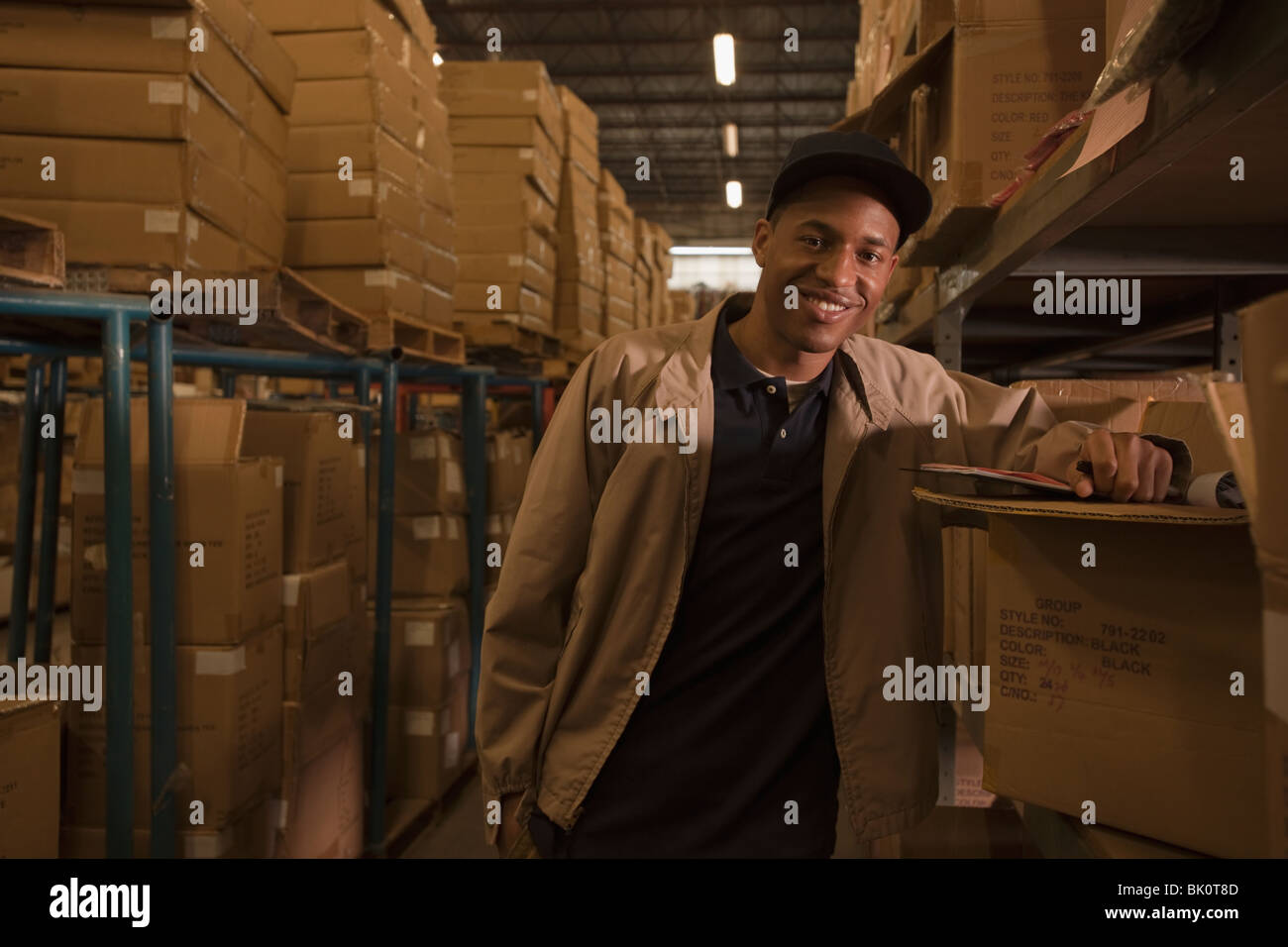 Black man working in warehouse Stock Photo - Alamy