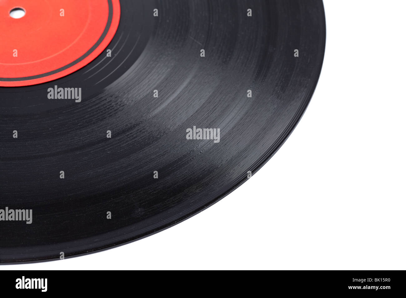 Dusty vinyl record with red label isolated on white background. Shallow ...