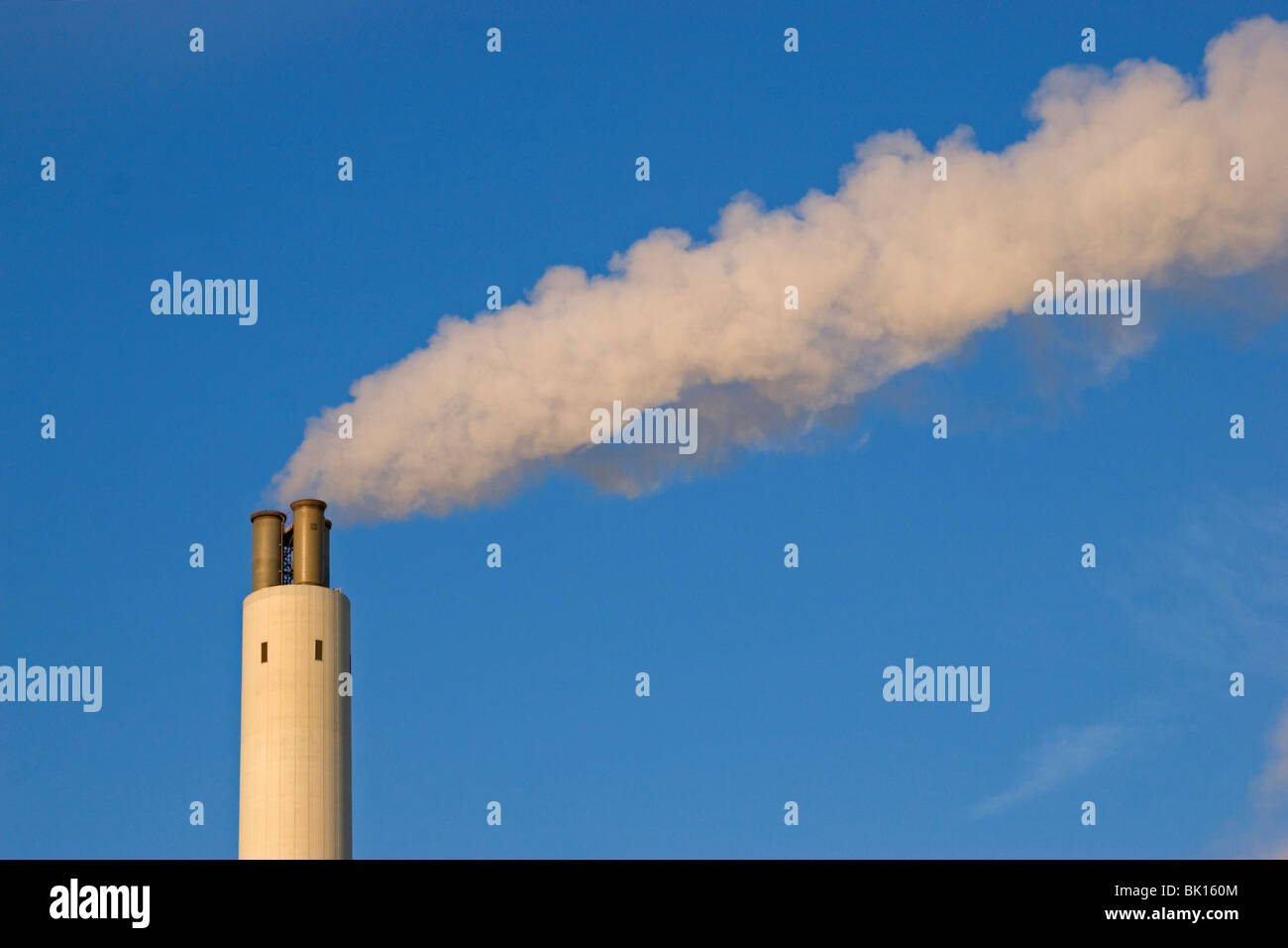 Smoking chimney with blue sky Stock Photo - Alamy