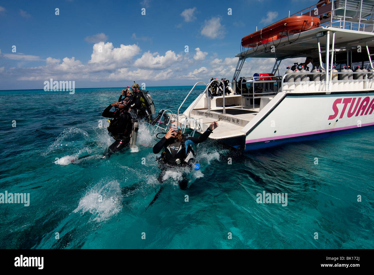 Scuba divers enter water from boat via giant stride entry Stock Photo ...
