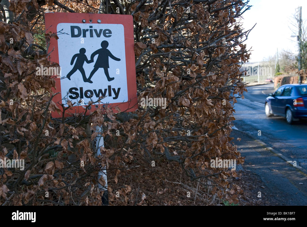 Drive Slowly road sign Stock Photo - Alamy