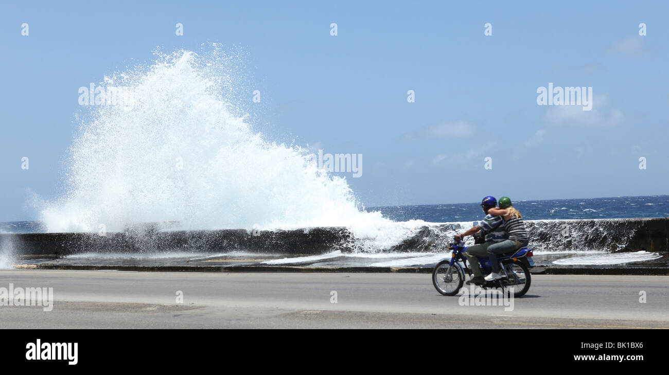The ocean rises over The Malecon, Havana, Cuba, and onto the road ...